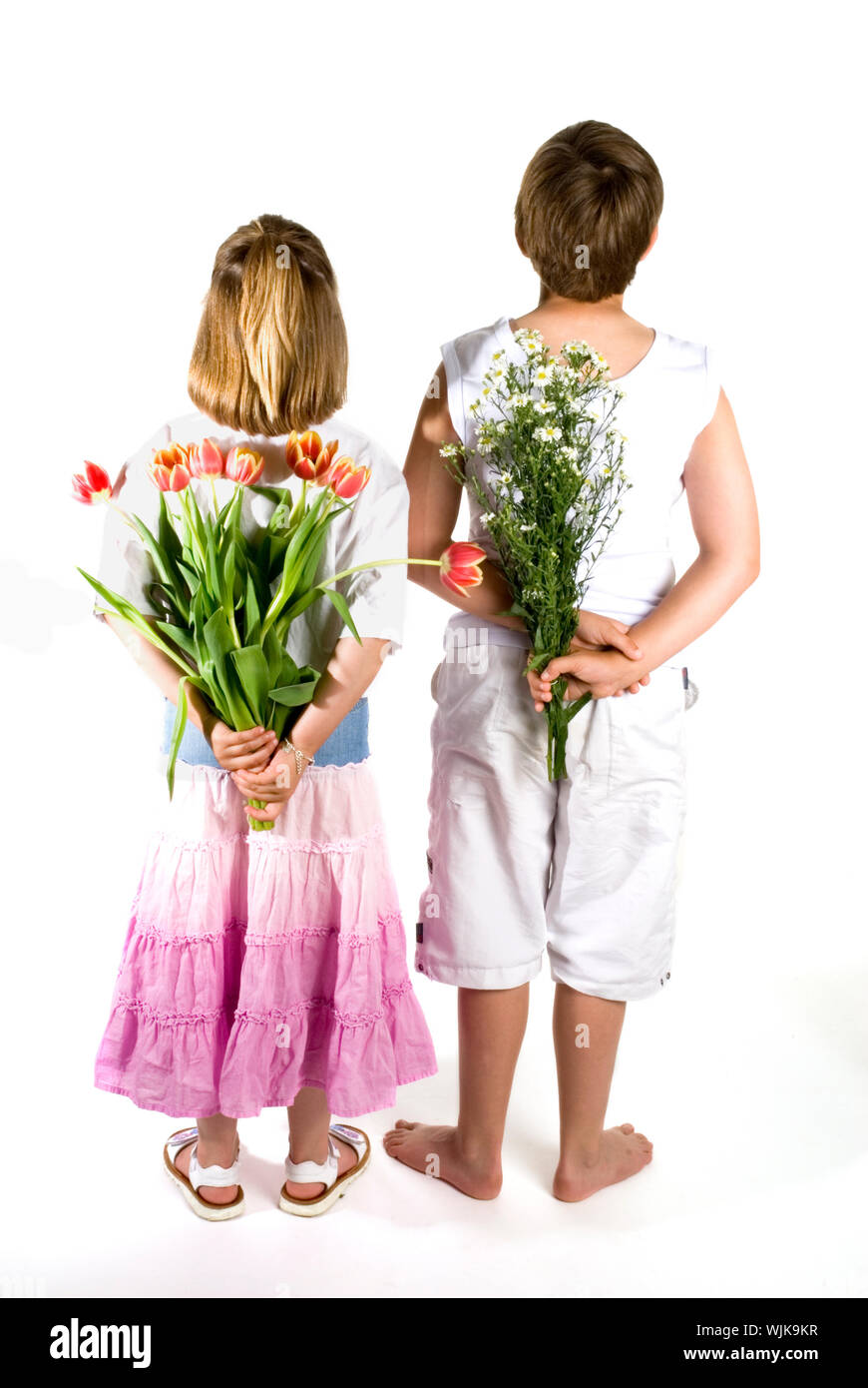 kids are giving you flowers by surprise Stock Photo - Alamy