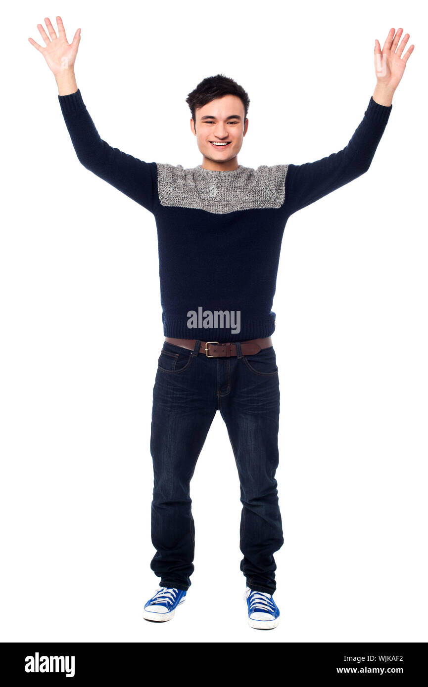 Young man with arms raised isolated over white Stock Photo - Alamy