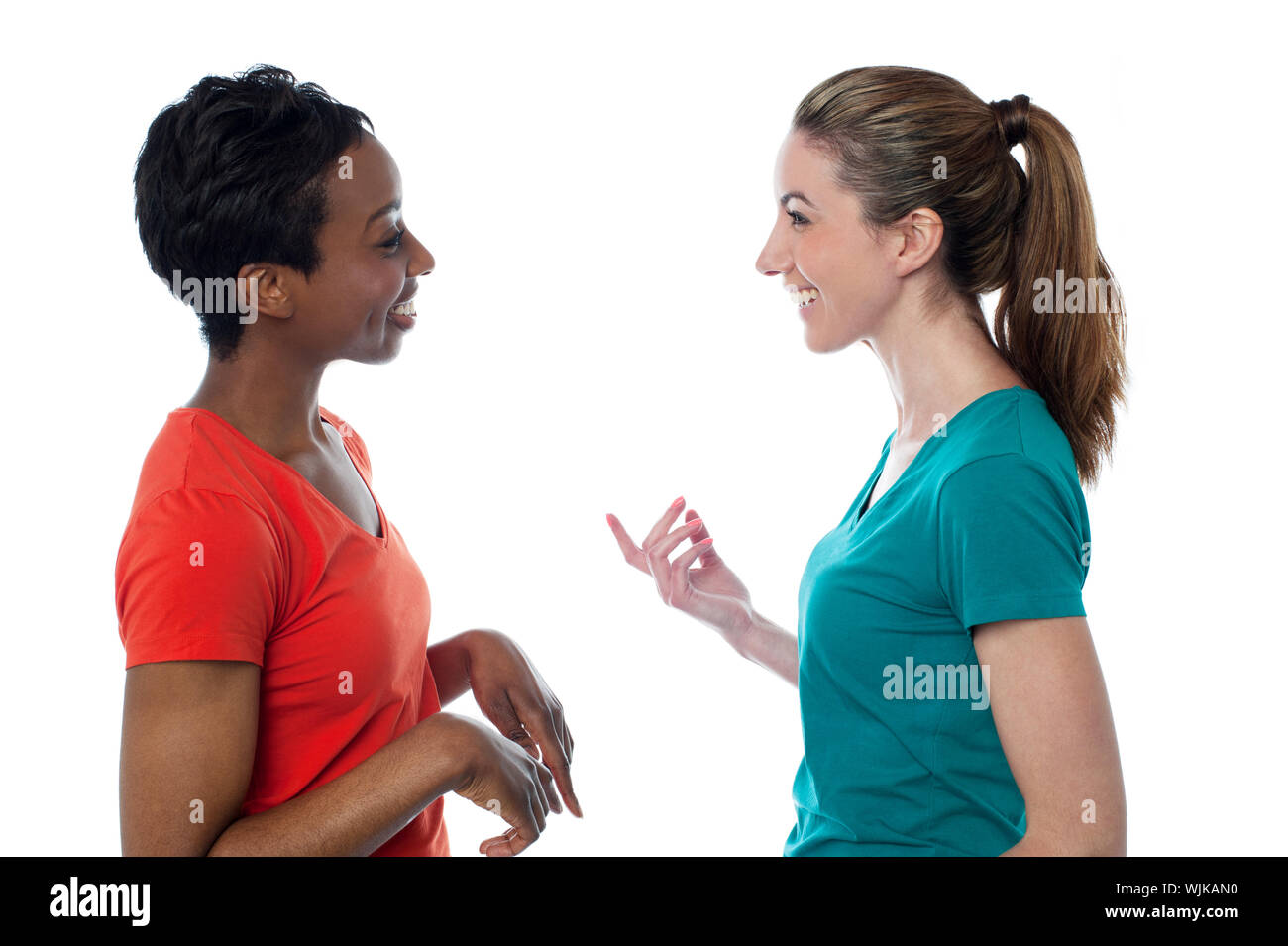 Two charming friends discussing something Stock Photo - Alamy