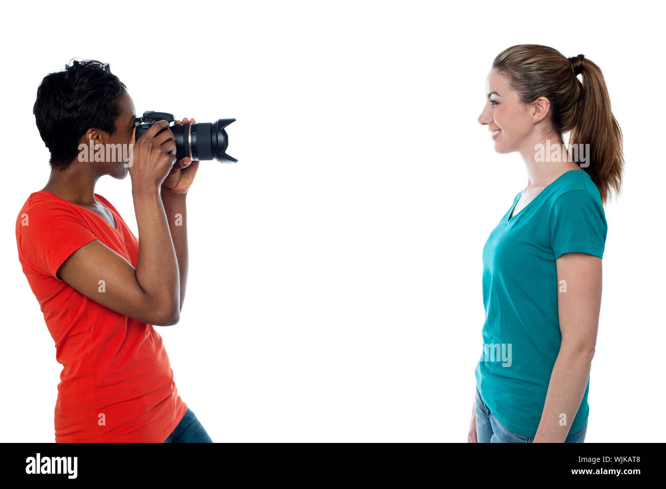 Woman taking a picture of her friend Stock Photo - Alamy