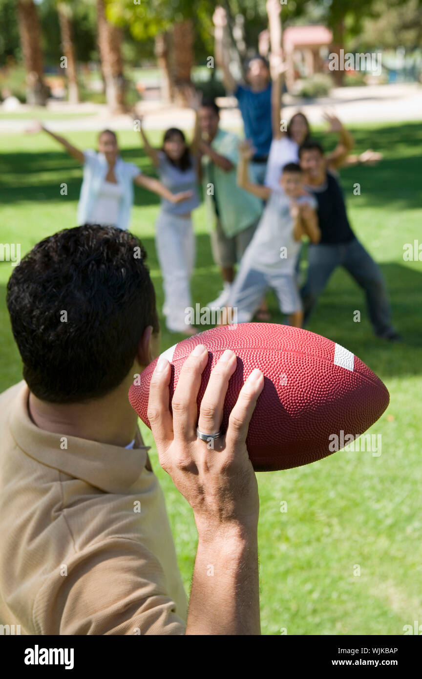 Man Throwing Football to Friends Stock Photo - Alamy