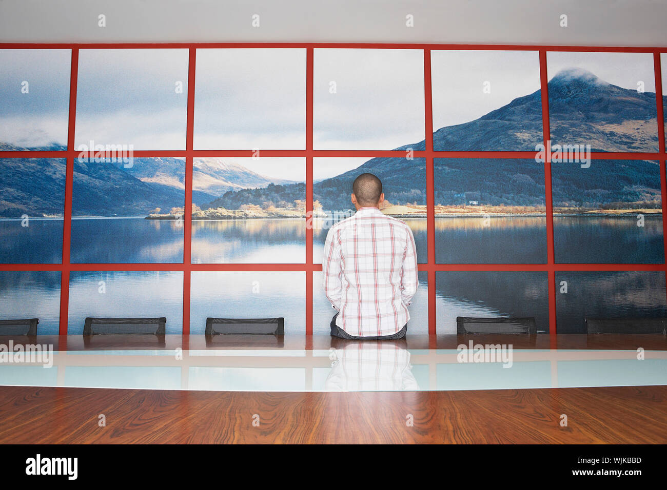 Man Staring at Wall Photo in Conference Room Stock Photo - Alamy