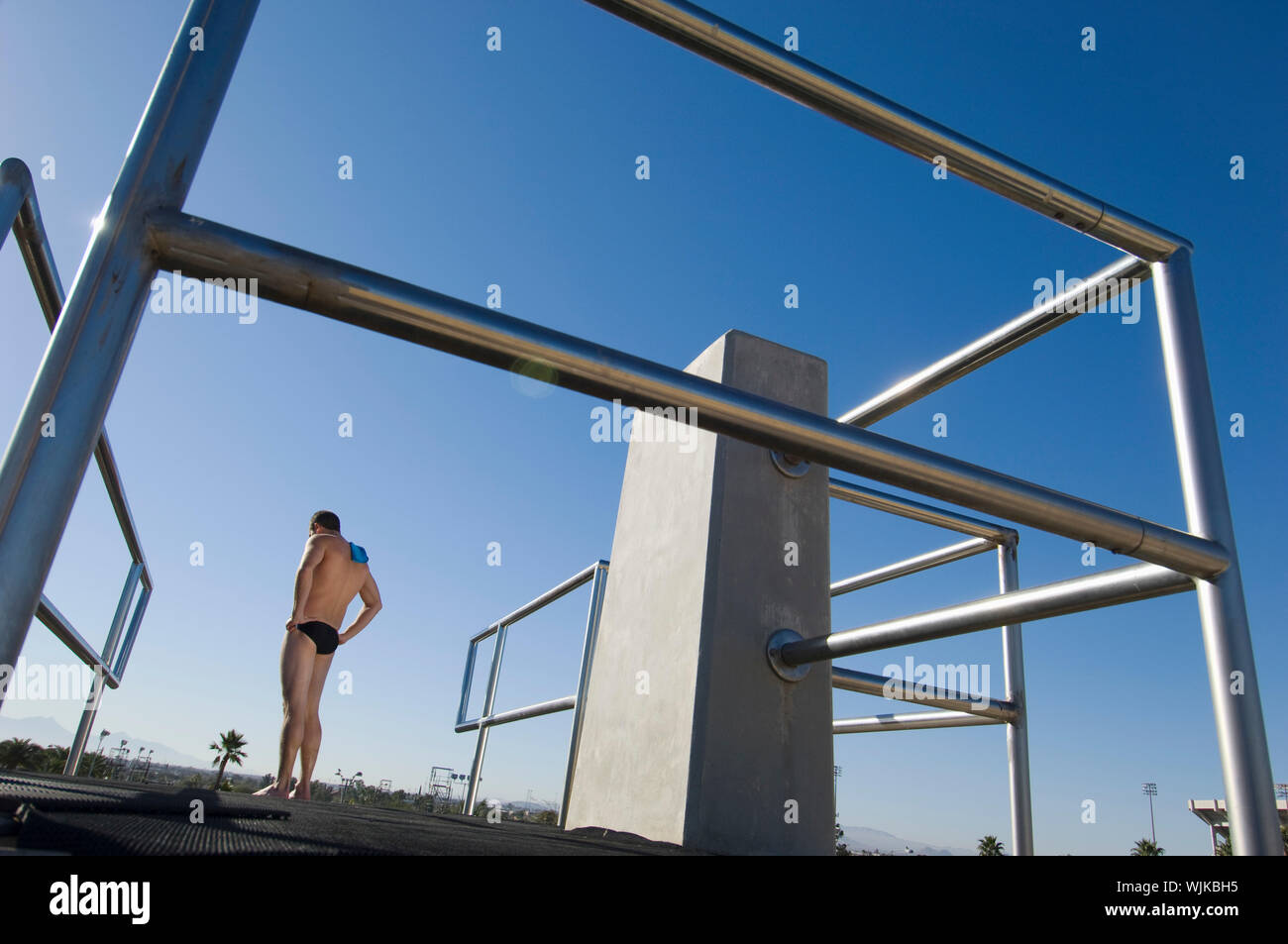 Swimmer standing on diving board Stock Photo - Alamy