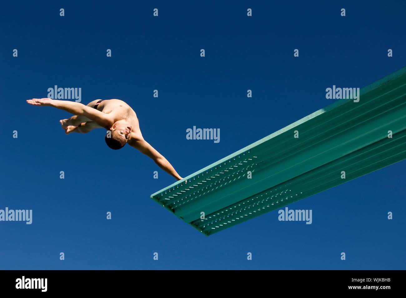 Swimmer Jumping into Swimming Pool Stock Photo - Alamy