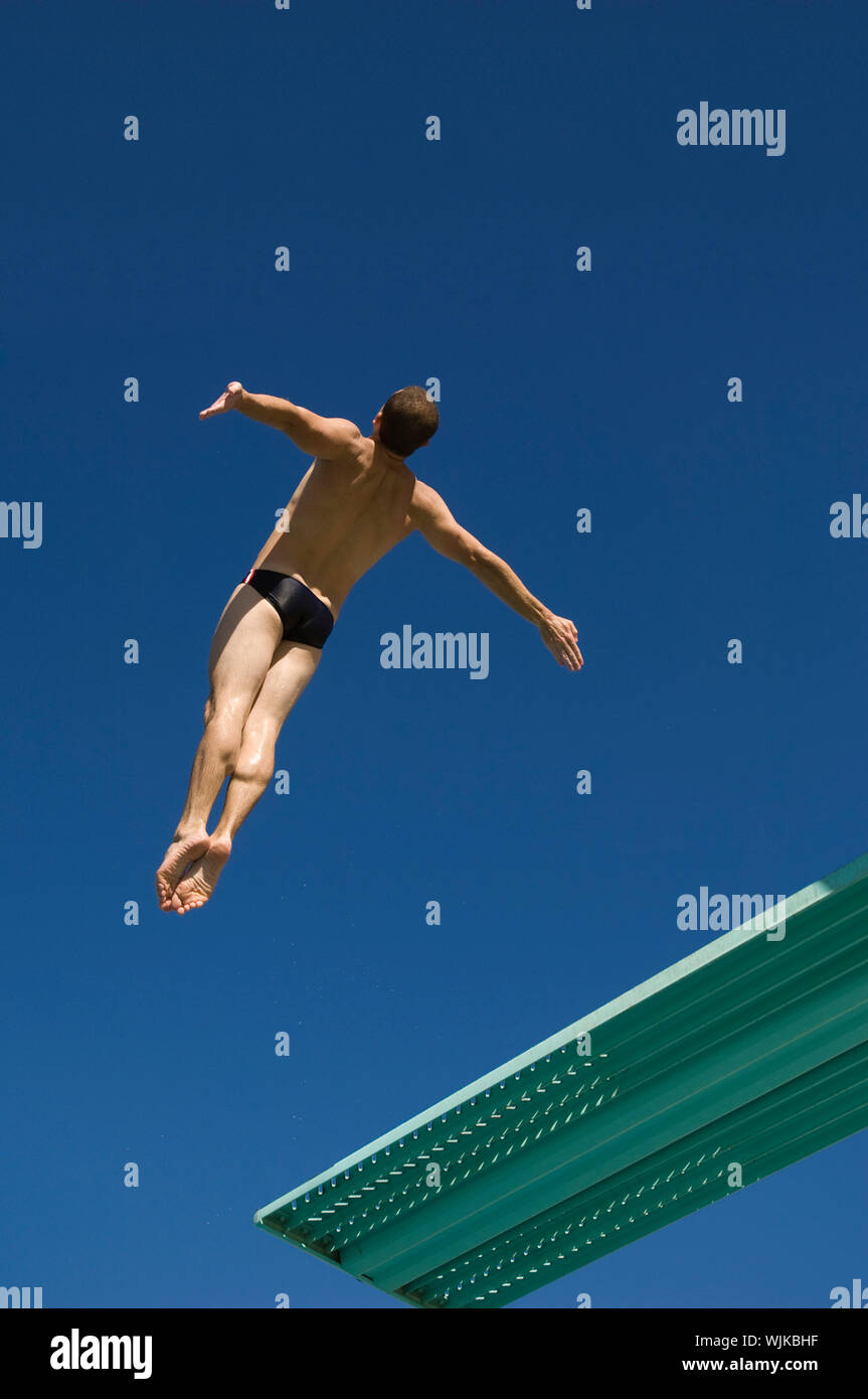 Swimmer diving into swimming pool Stock Photo - Alamy
