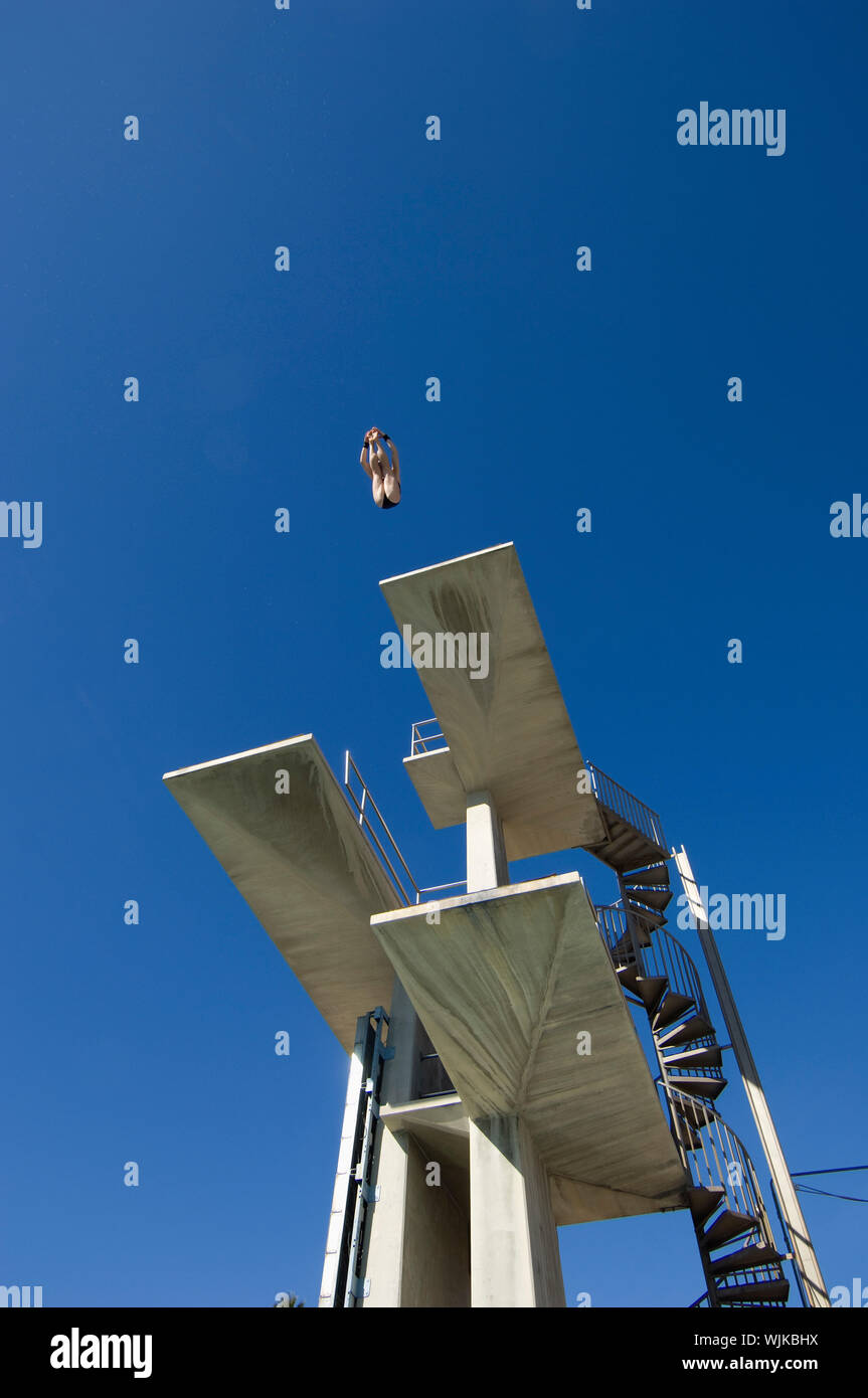 Swimmer diving from diving board Stock Photo - Alamy