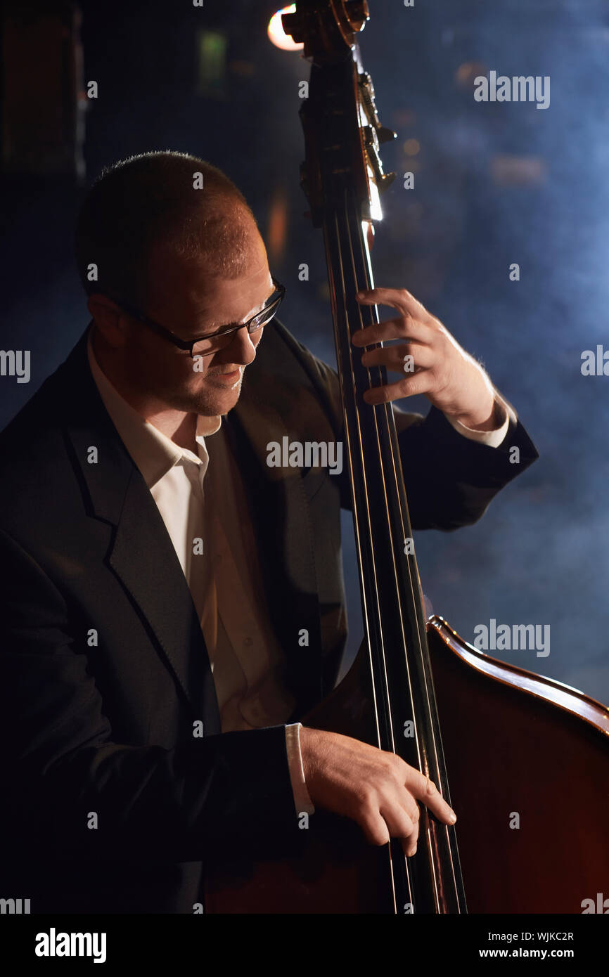 Man playing the double bass on stage Stock Photo - Alamy
