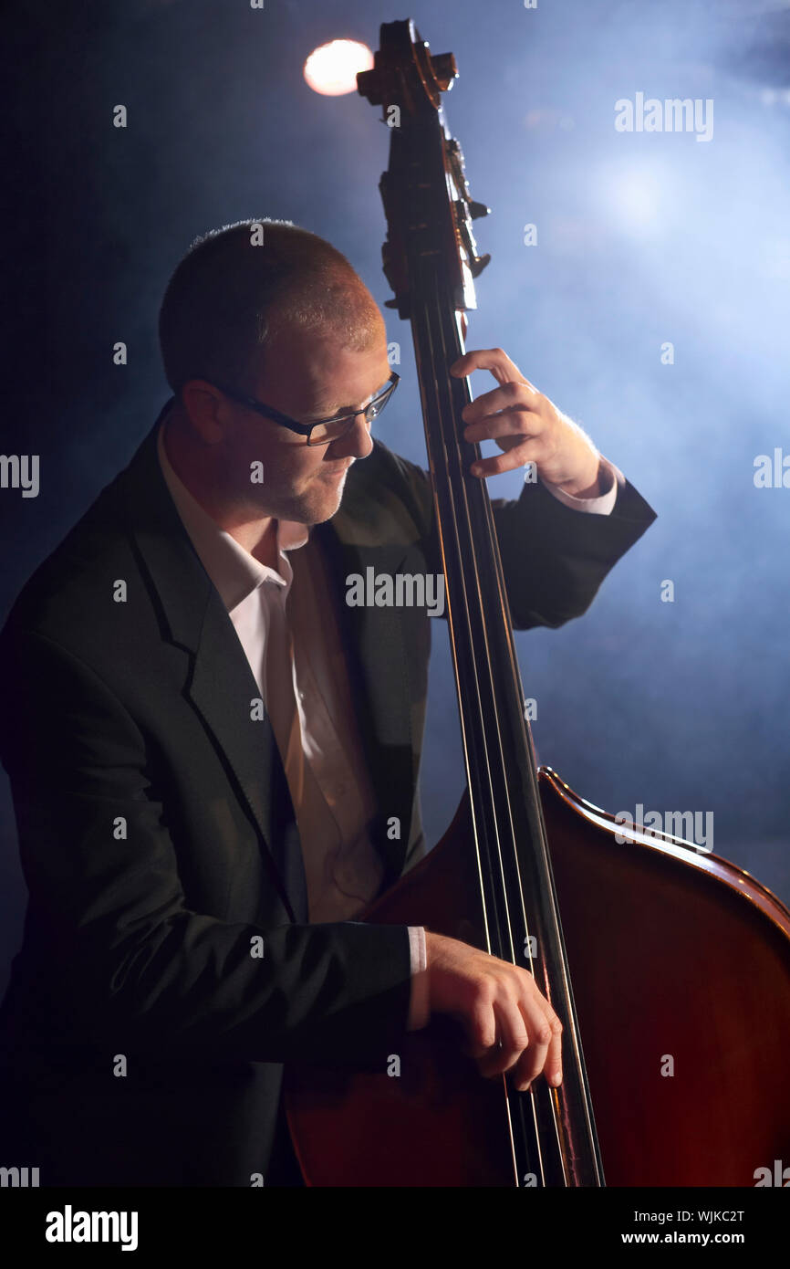 Man playing the double bass on stage Stock Photo - Alamy