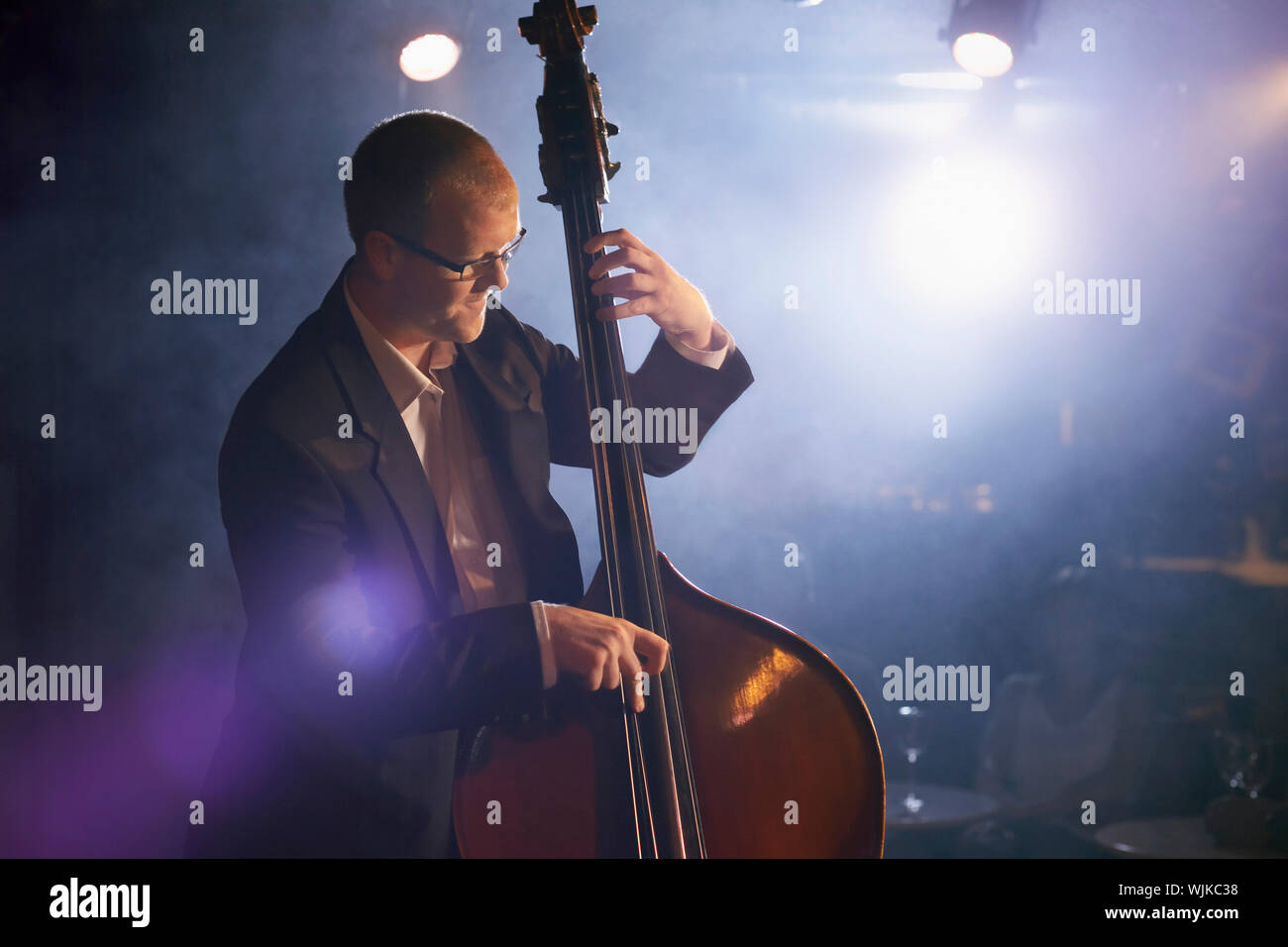 Man playing the double bass on stage Stock Photo - Alamy