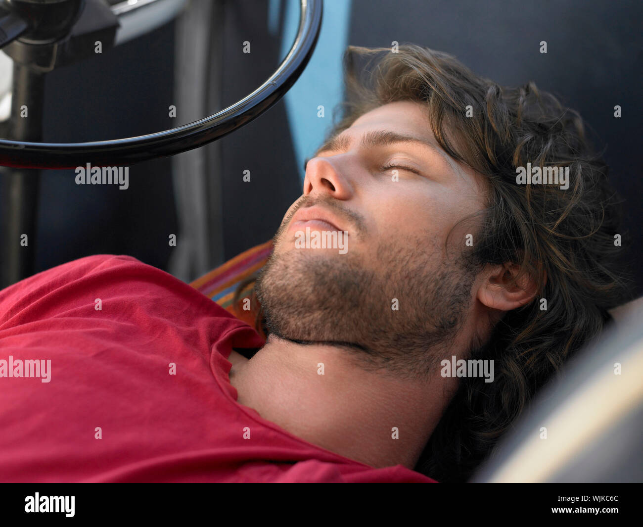 Young Man Sleeping in Vehicle Stock Photo - Alamy