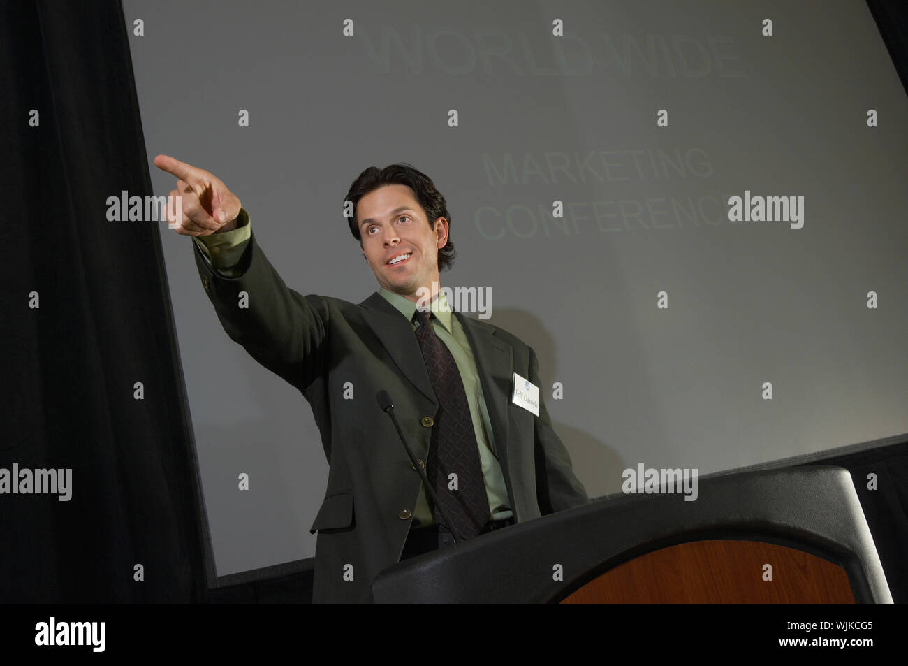 Smiling man pointing during presentation hi-res stock photography and ...