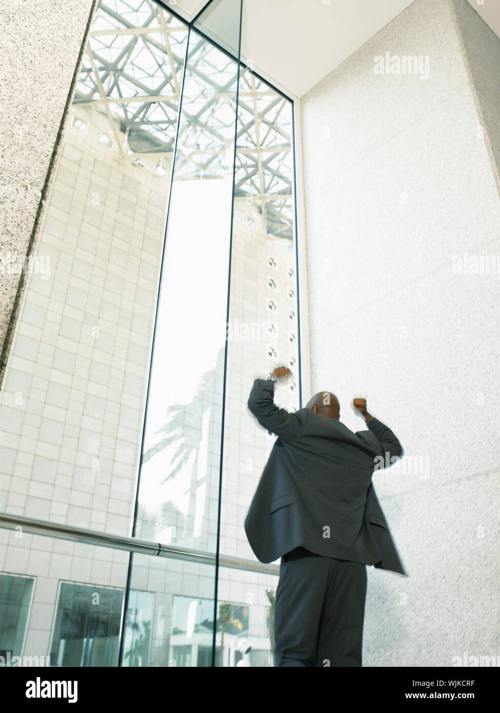 Low angle rear view of an African American businessman celebrating ...