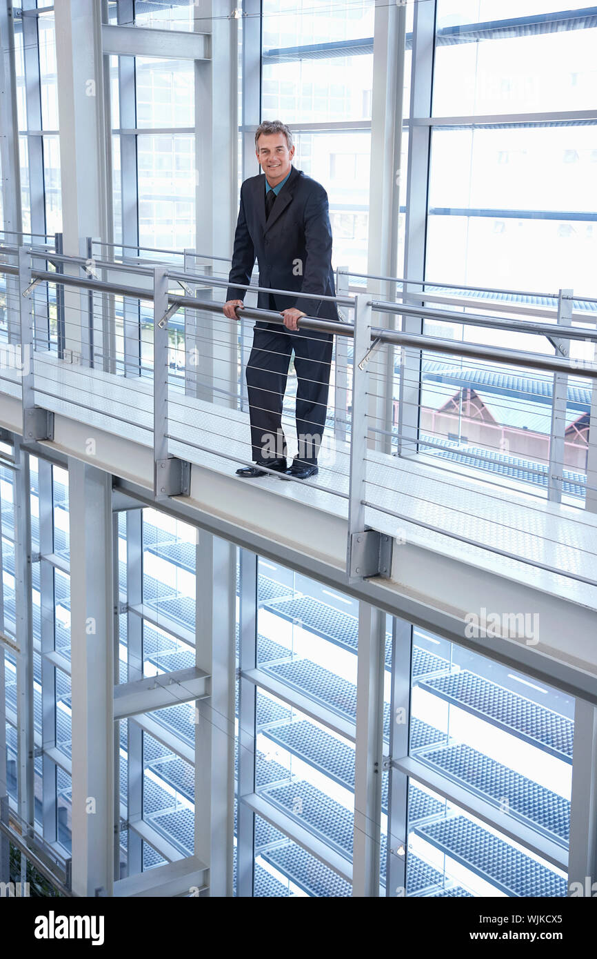 Full length portrait of happy middle aged businessman standing by ...