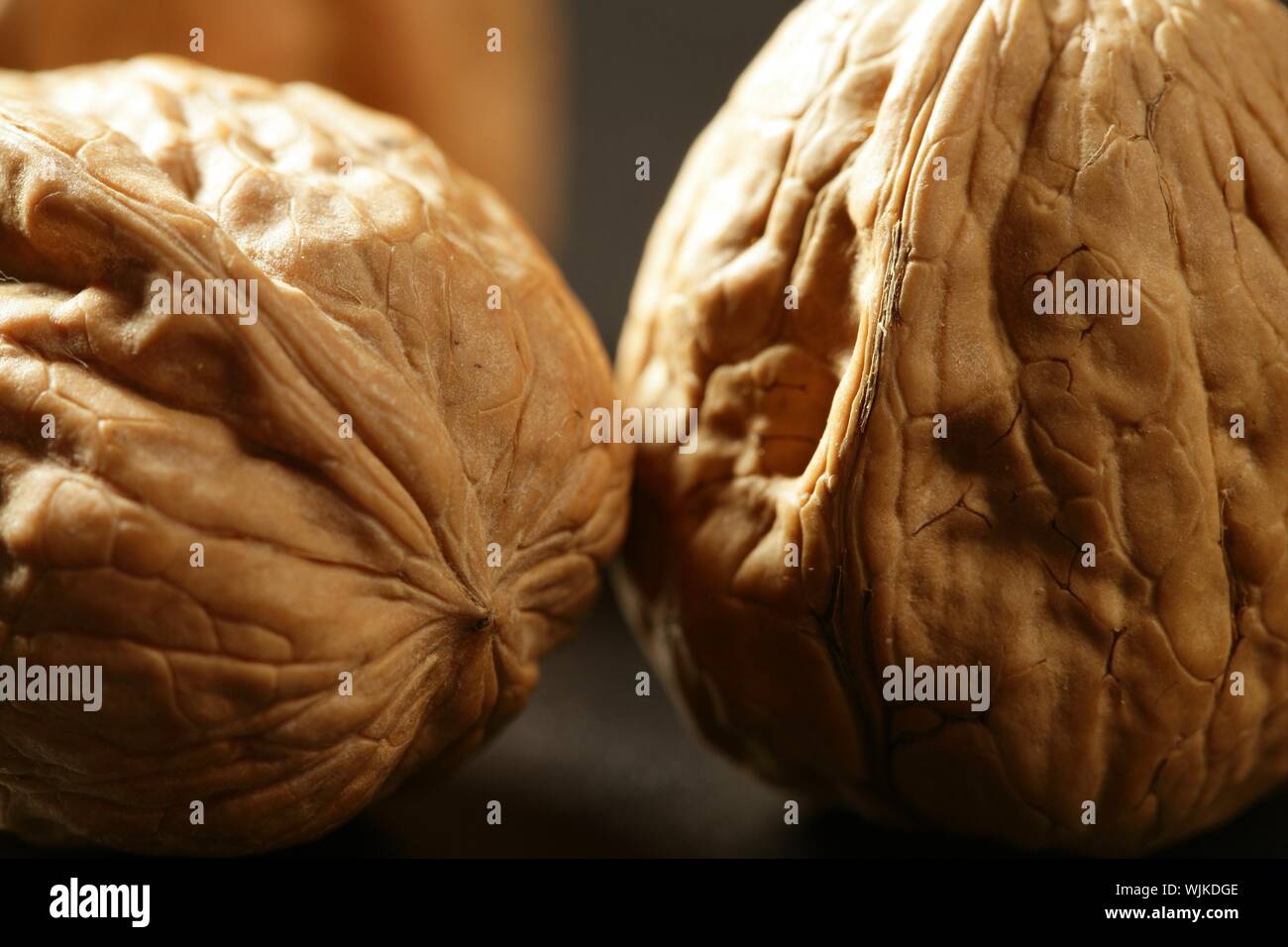 Three walnuts with shells over black background and shadows Stock Photo ...