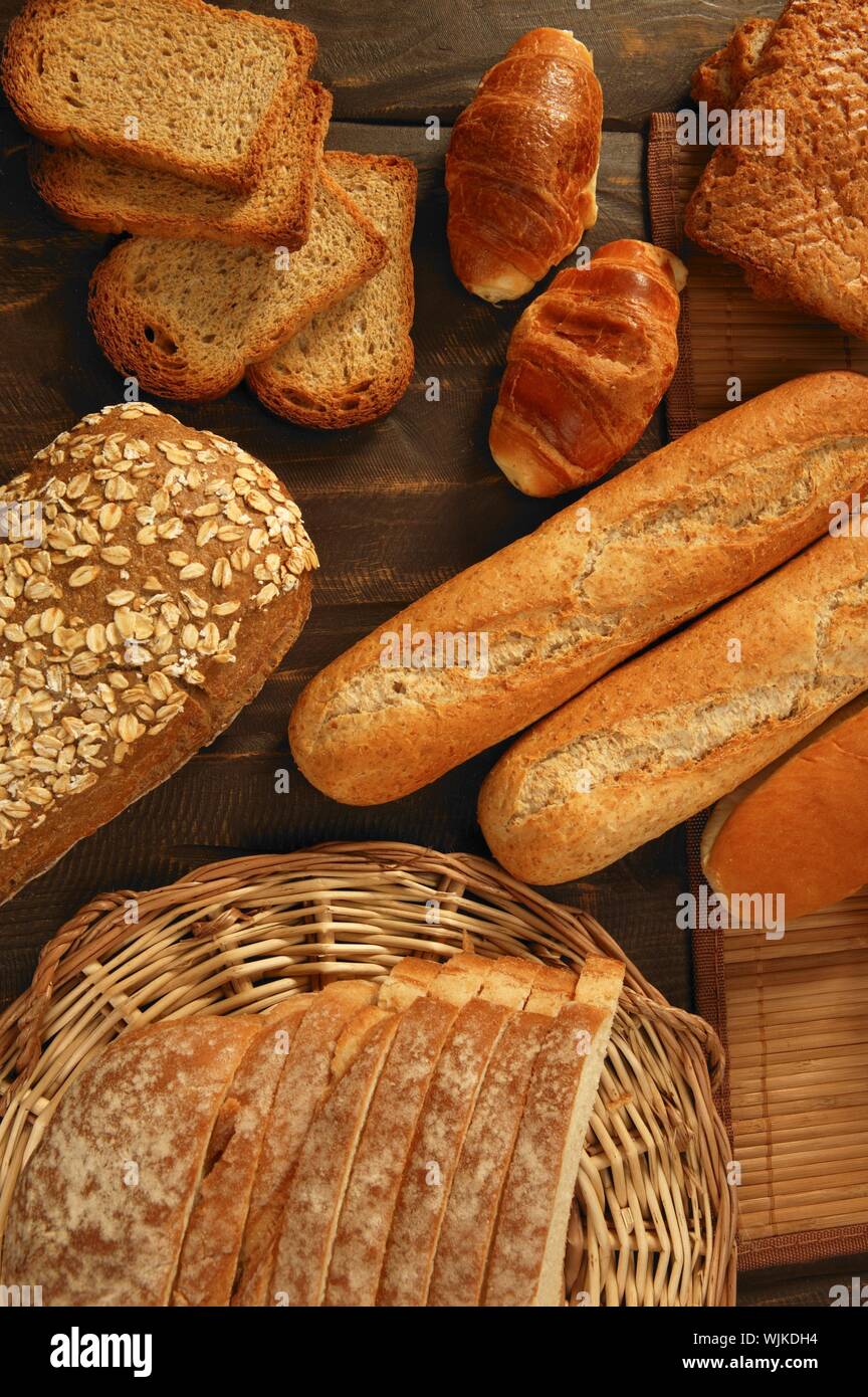 Varied bread still life over dark wood background Stock Photo - Alamy