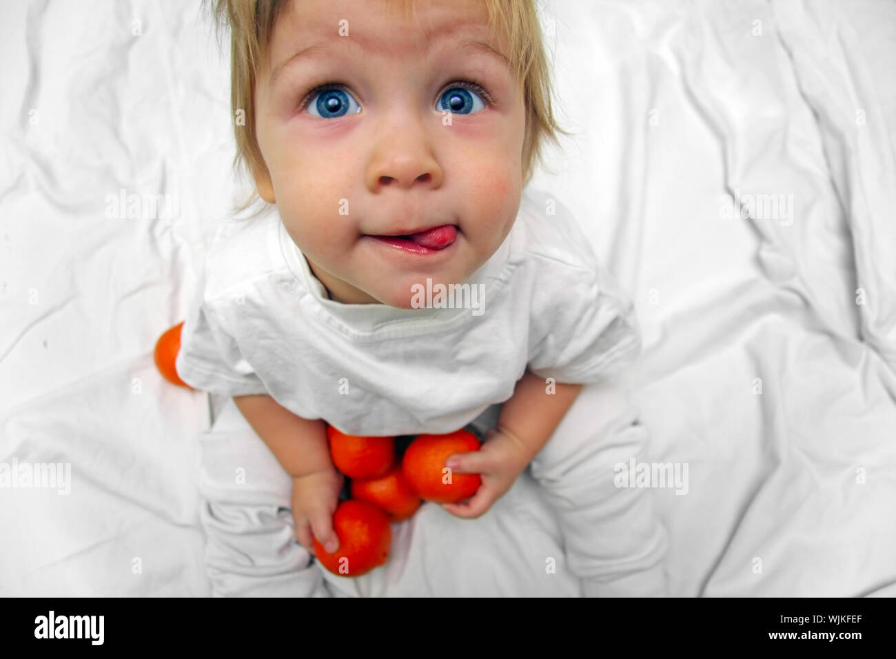 little boy with oranges licked Stock Photo - Alamy