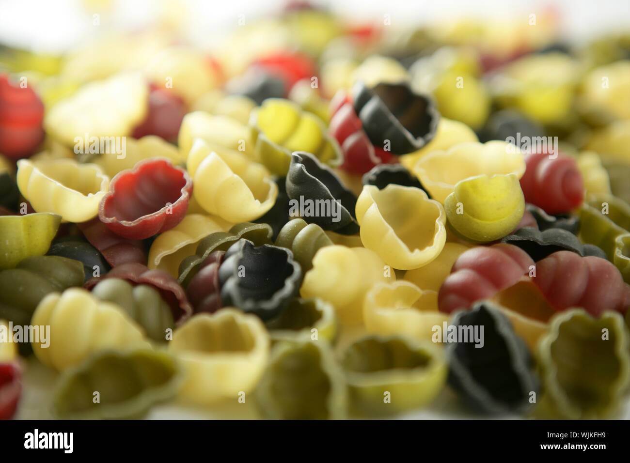 Italian pasta texture, multicolor, clam shell shape Stock Photo - Alamy