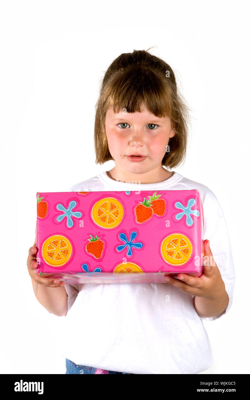 little girl with a colourful wrapped present for you Stock Photo - Alamy