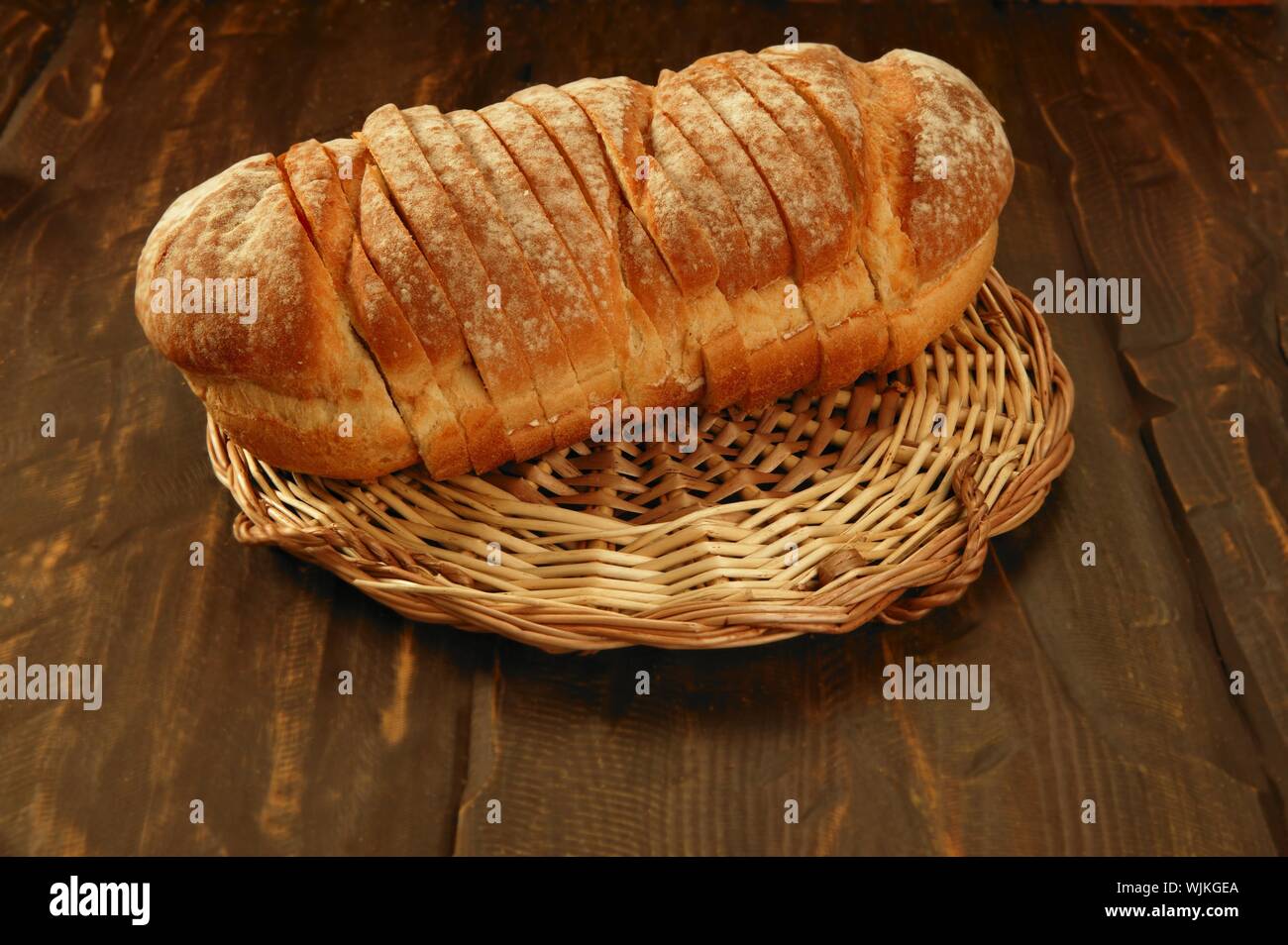 Golden sliced bread classic still over dark wood background Stock Photo ...
