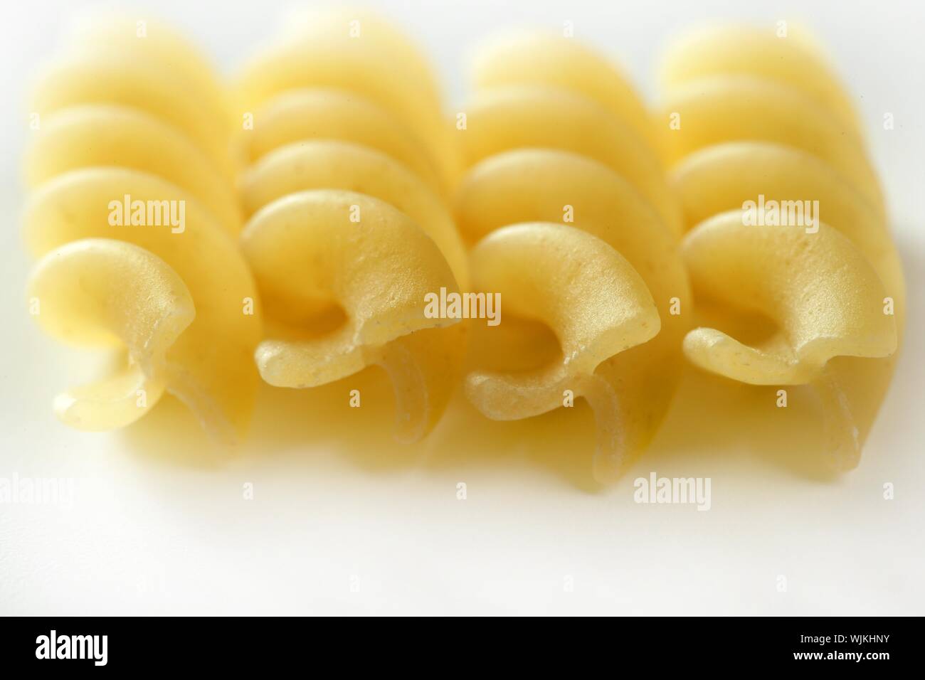 Spiral fusilli dired pasta macro over white studio background Stock ...