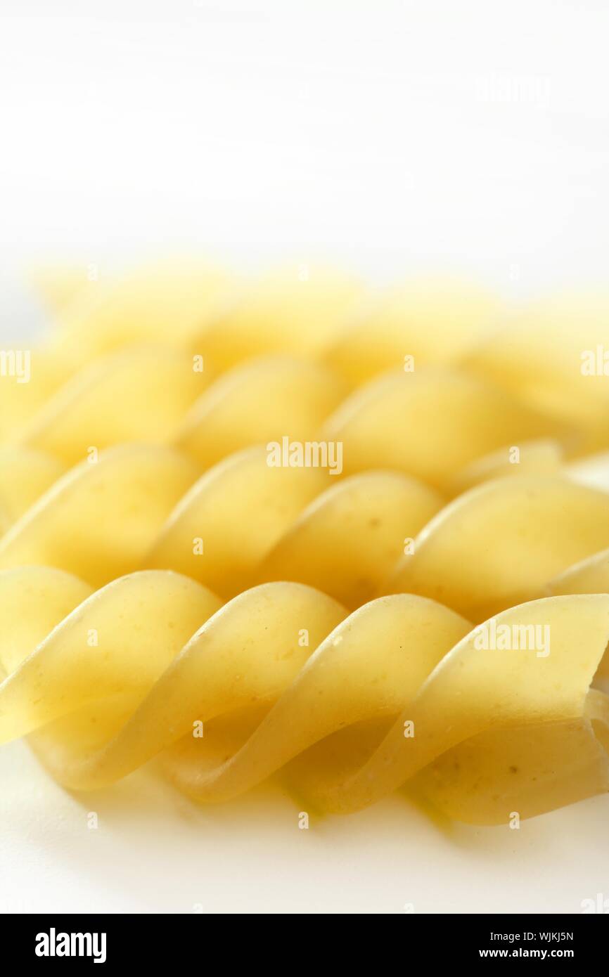 Spiral fusilli dired pasta macro over white studio background Stock ...