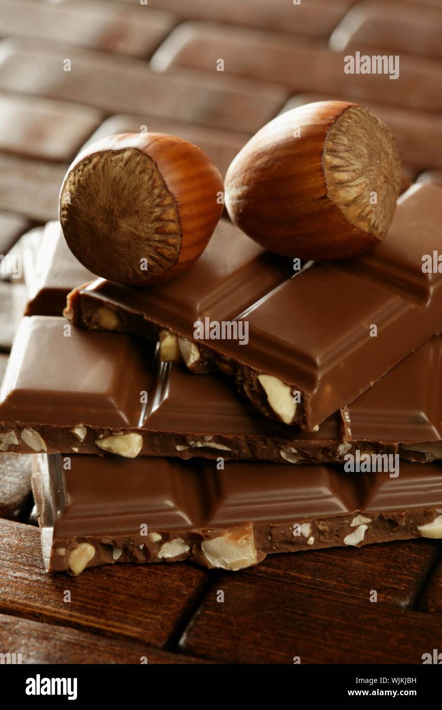 Hazelnuts and chocolate on brown wood enviroment at studio Stock Photo ...