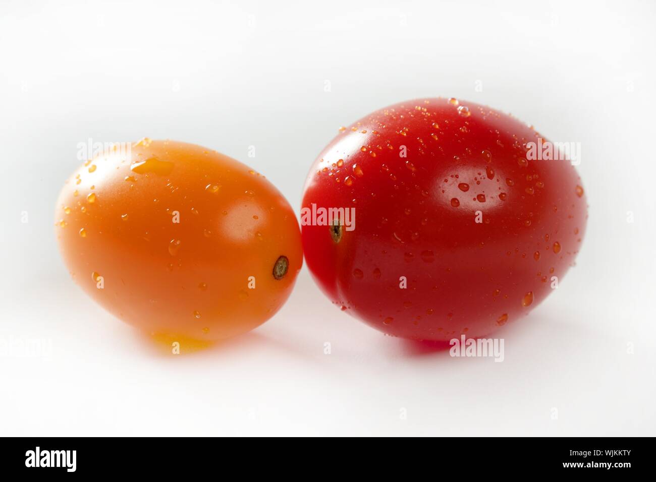 Little cherry varied multi color tomatoes, at studio, white background ...