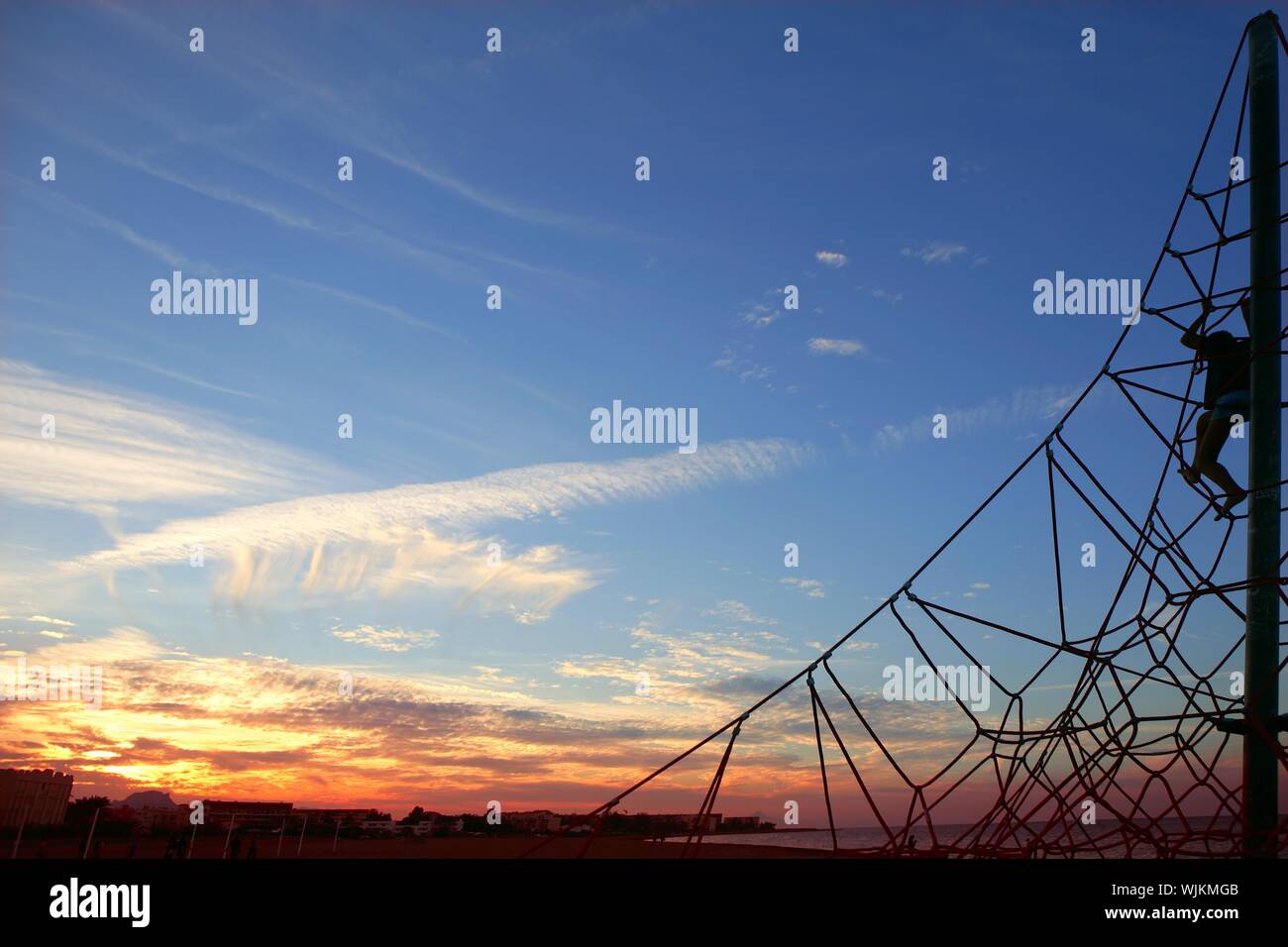 Silhouette children playing in playground hi-res stock photography and ...
