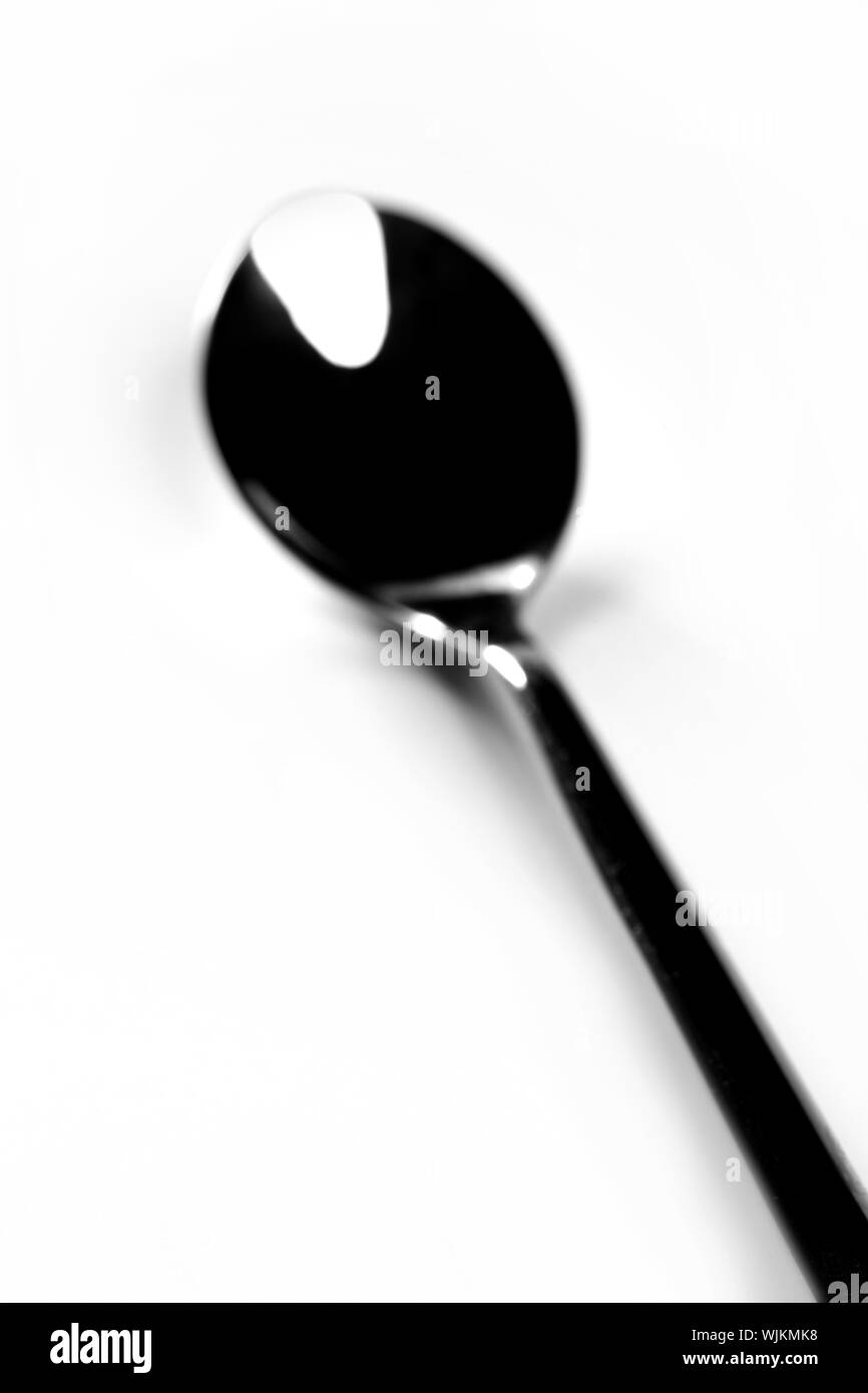 One spoon isolated on white background, high contrast blur image ...