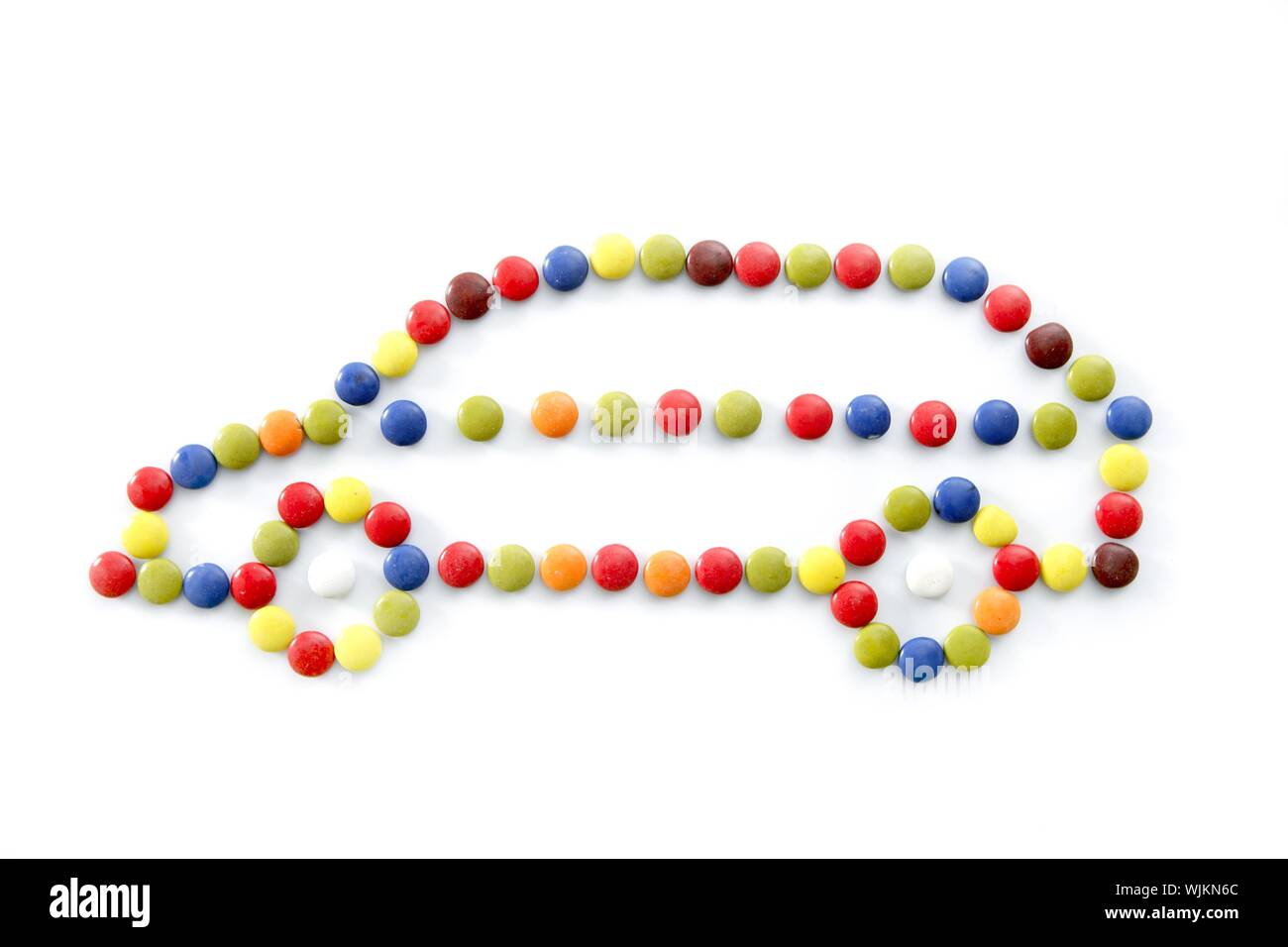 candy car made of little chocolate color sweets, isolated over white ...