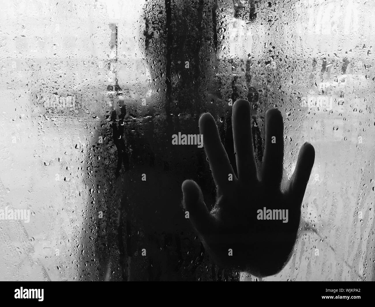 Touching hand glass Black and White Stock Photos & Images - Alamy