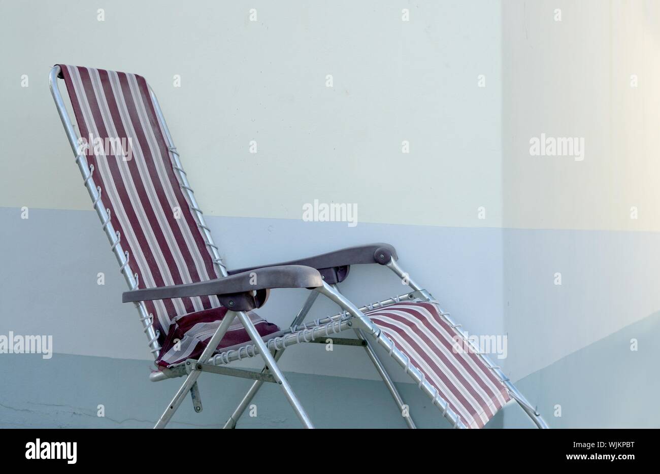 Alone summer chair over blue wall background, chill mediterranean ...