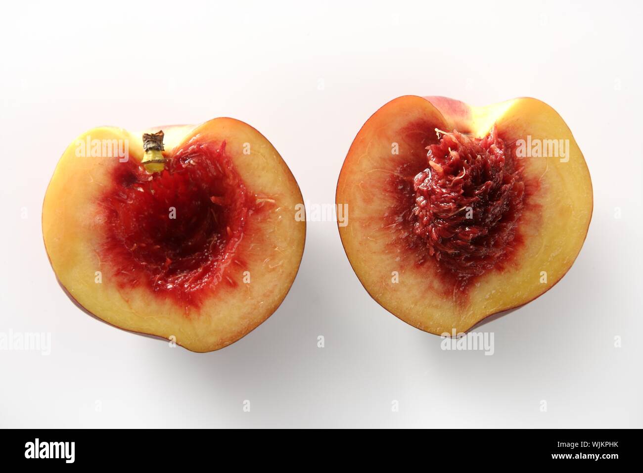 Metaphor of bloody inside of half peach Stock Photo - Alamy