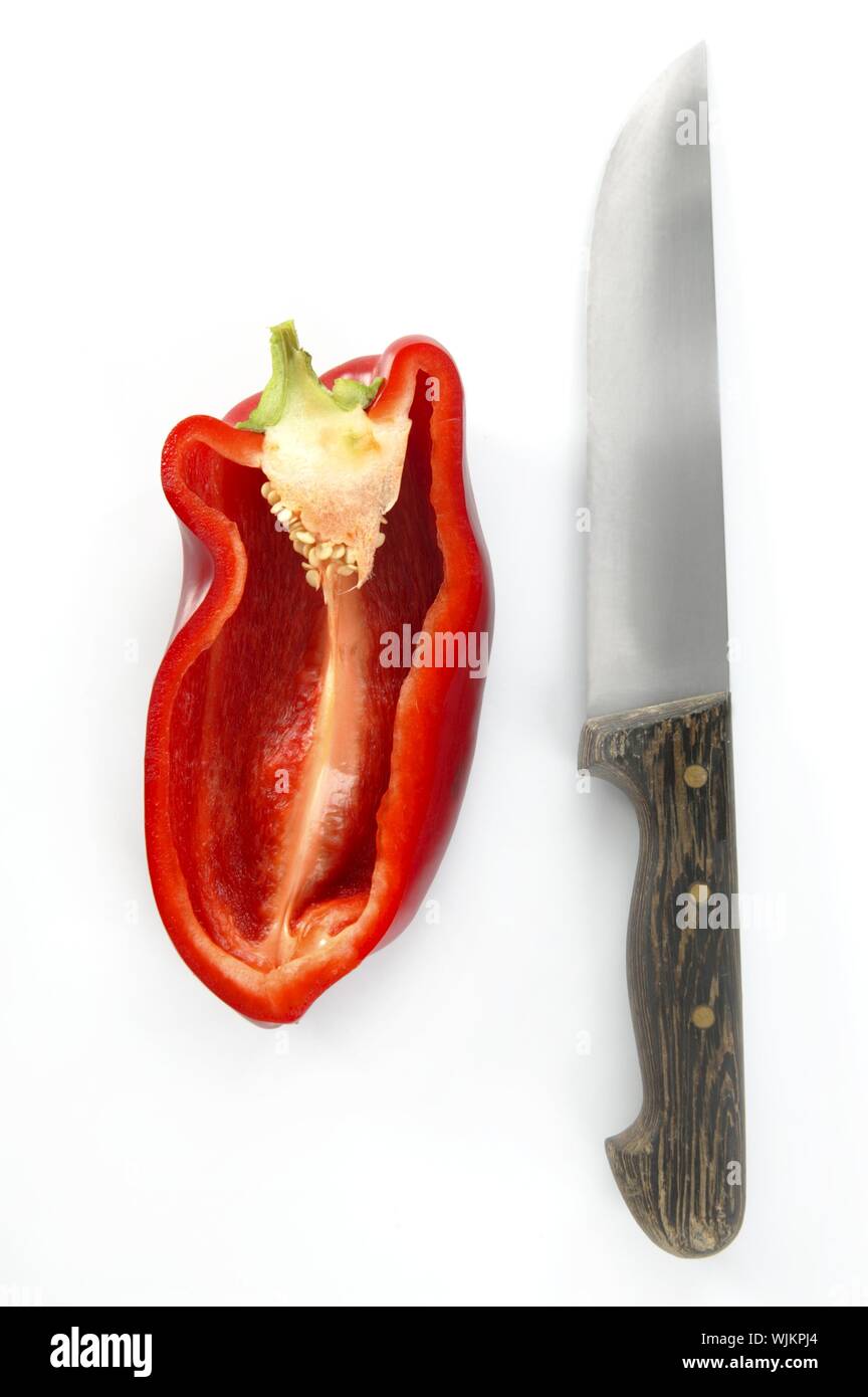 Half red pepper and knife isolated over white studio background Stock ...