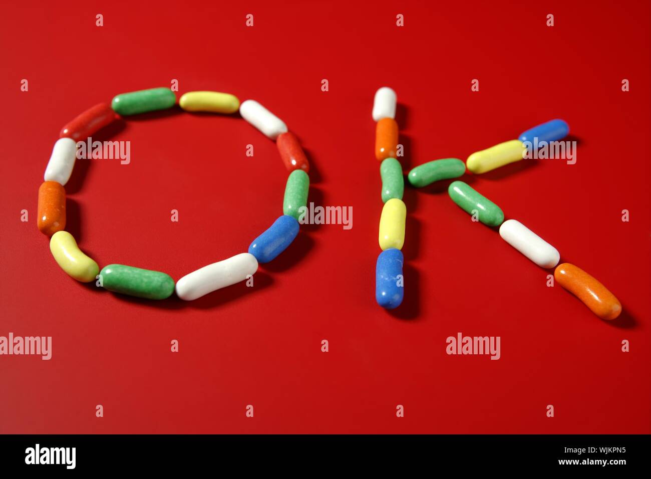 Candy colorful sweets with letter shapes spelling the word OK Stock ...