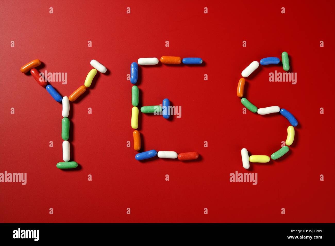 Candy colorful sweets with letter shapes spelling the word YES, over ...