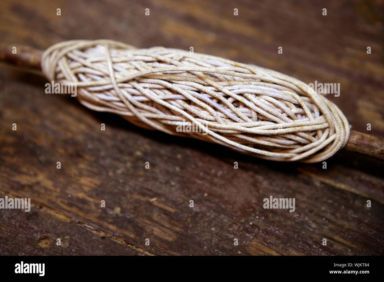 Thread old spool over an aged brown wooden surface Stock Photo - Alamy