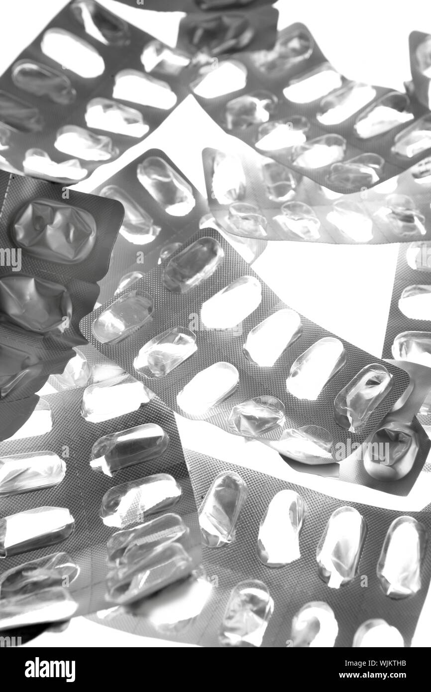 Pills tabs blister silver texture over white background Stock Photo - Alamy