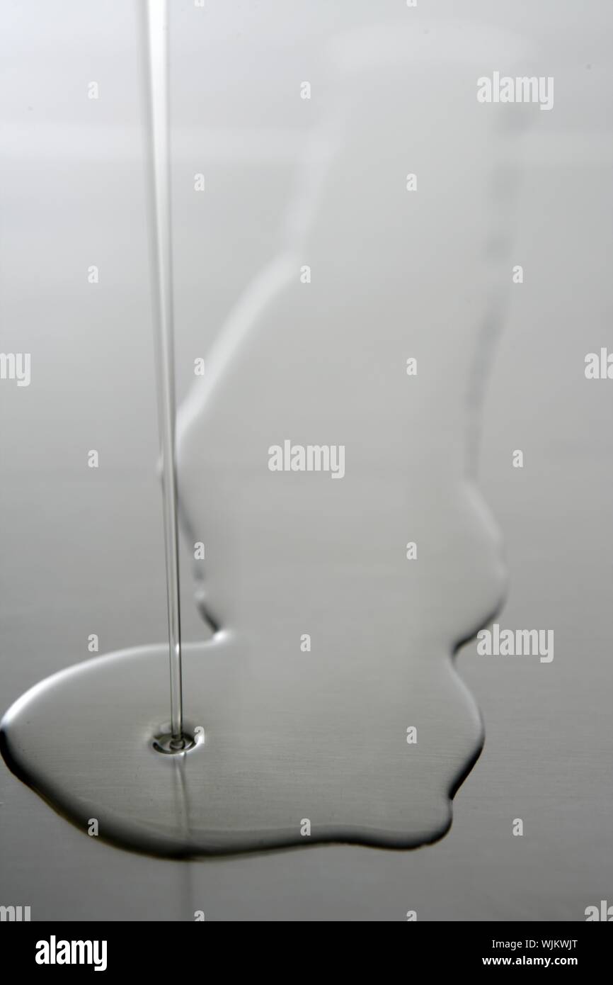 Liquid,transparent oil shape on a stainless steel metal surface Stock ...