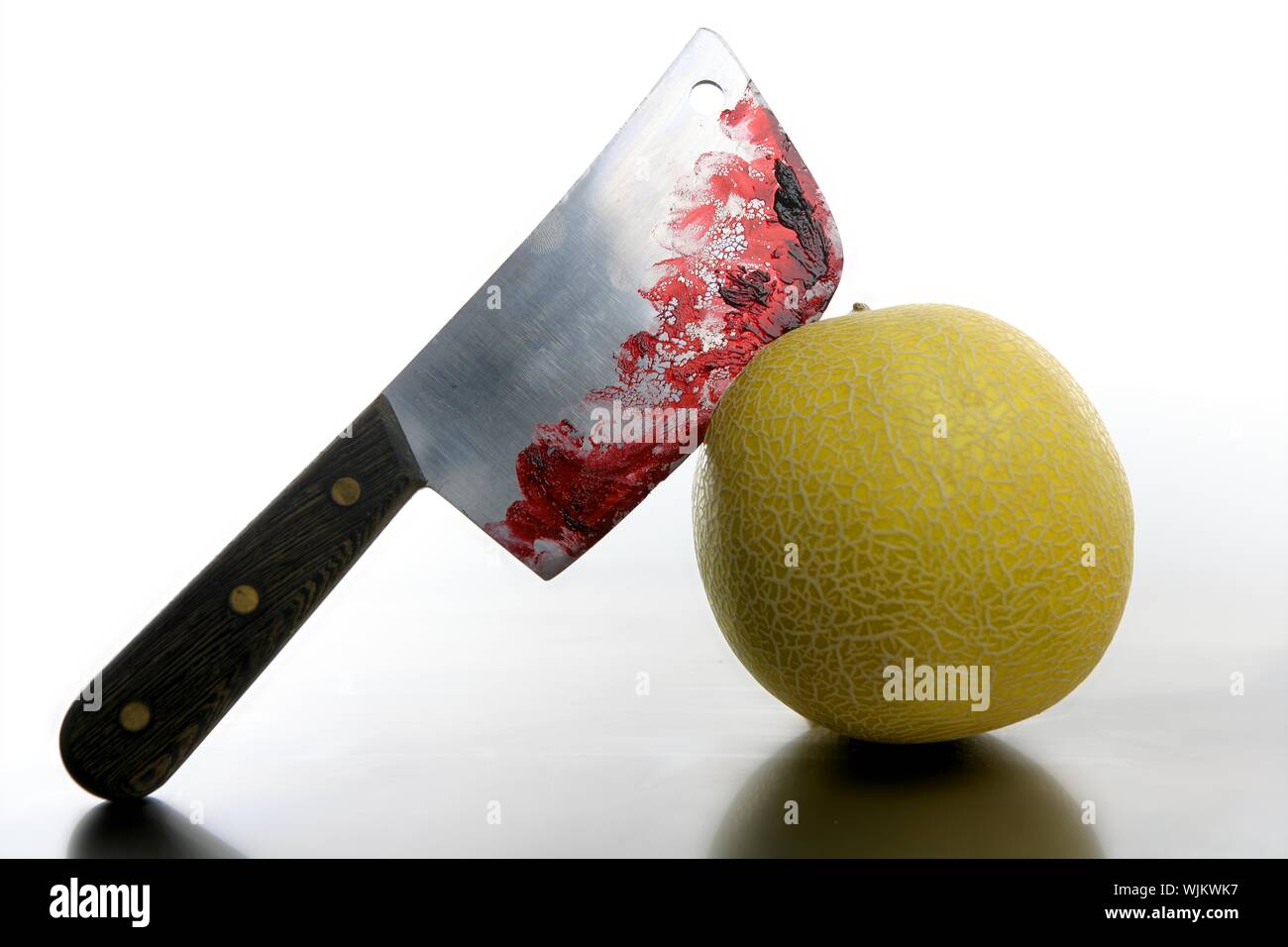 Bloody yellow melon killed by knife. Wound with blood metaphor Stock ...