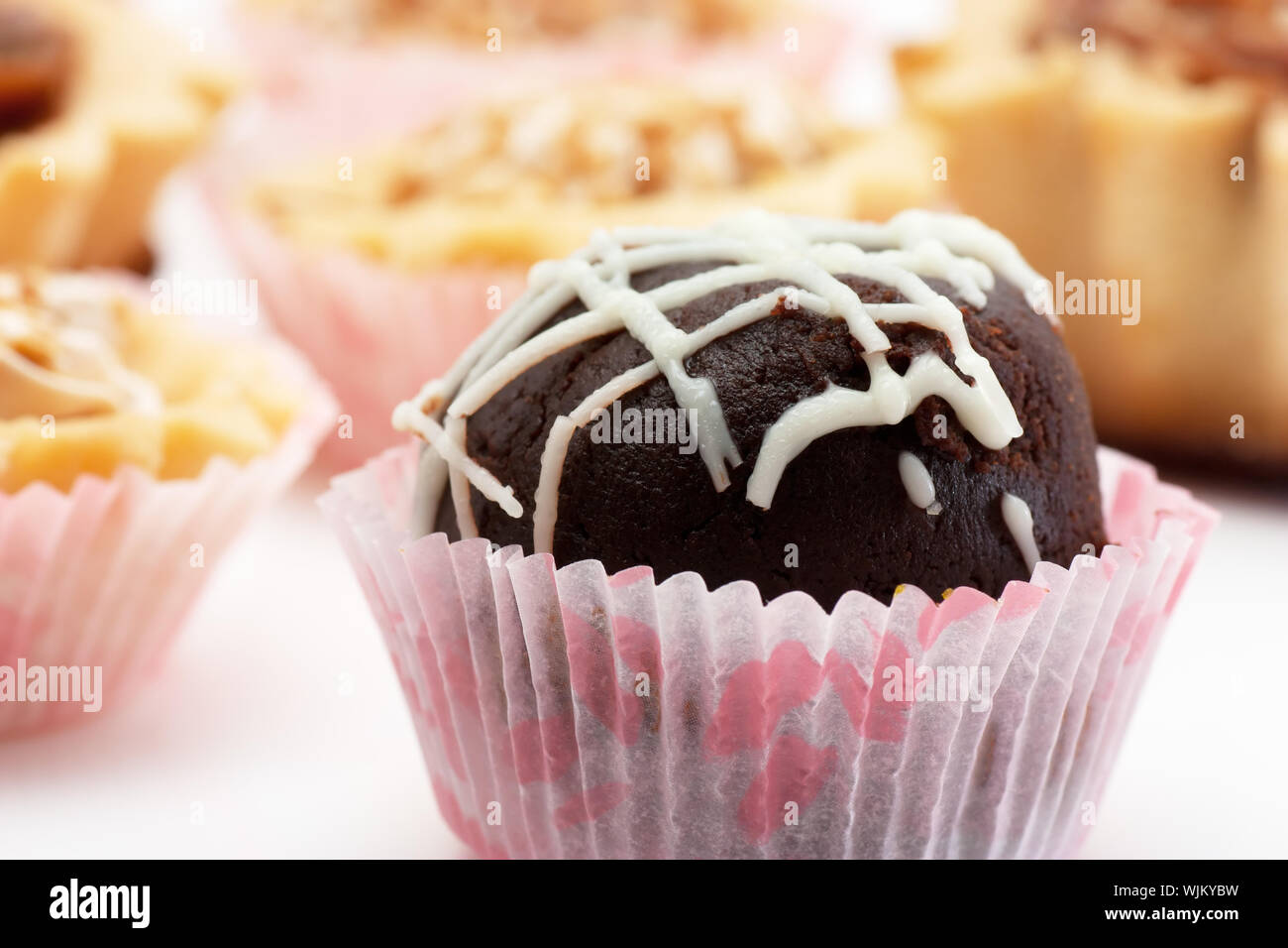 Chocolate pastries and some other pastries at background Stock Photo ...