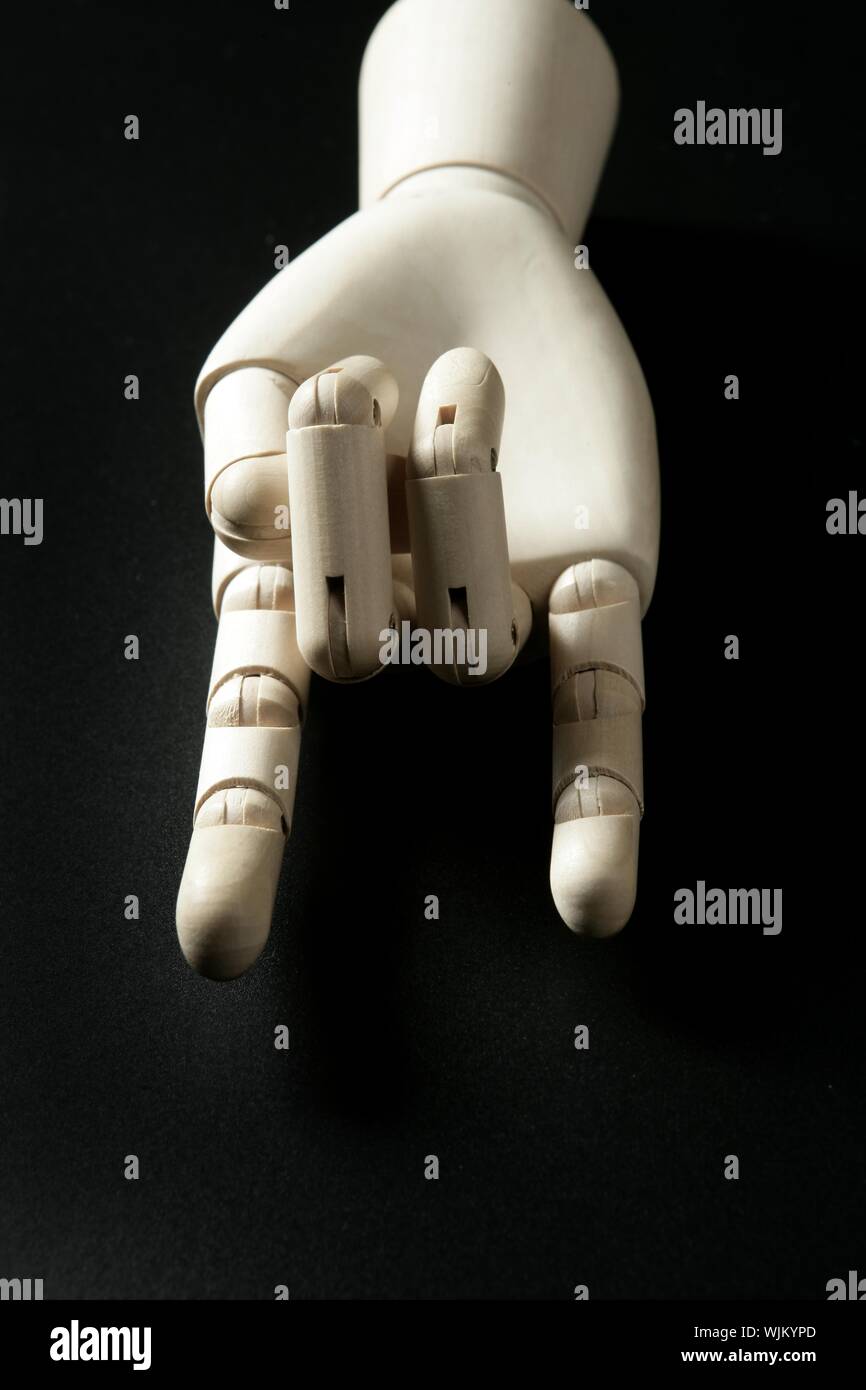 Mannequin wooden hand, horns with two fingers Stock Photo - Alamy
