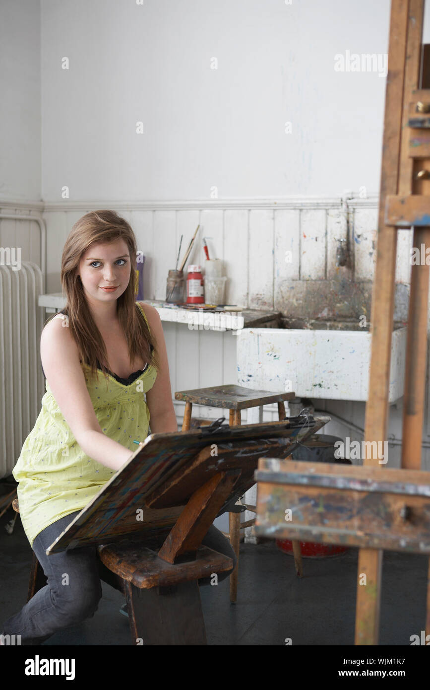 Beautiful female artist drawing in studio Stock Photo - Alamy