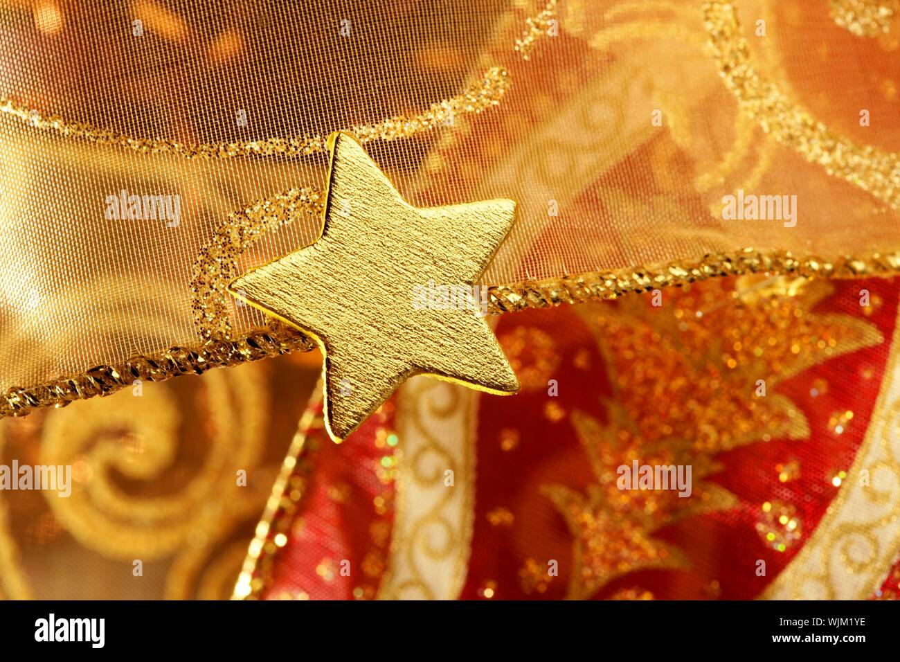 Christmas golden decoration with gold star over red background Stock ...
