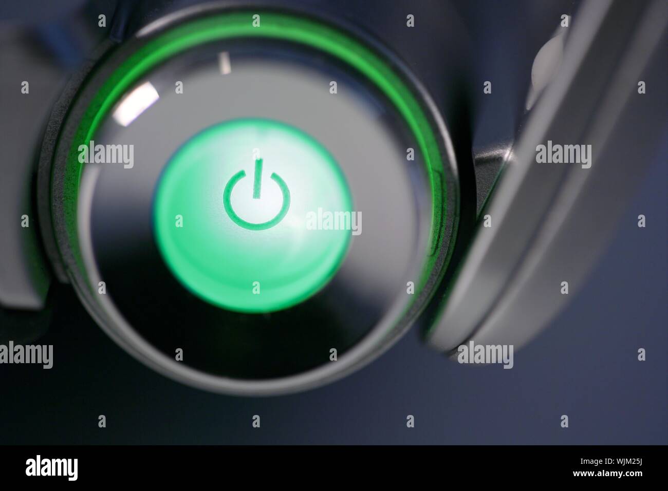 Green computer power on button with glowing light Stock Photo - Alamy