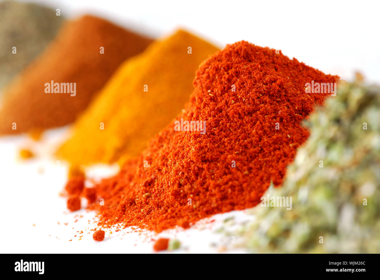 Heaps of various ground spices on white background Stock Photo - Alamy