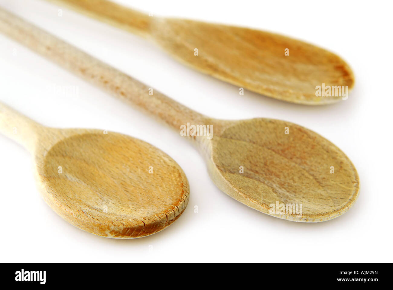 Old wooden cooking spoons isolated on white background Stock Photo - Alamy