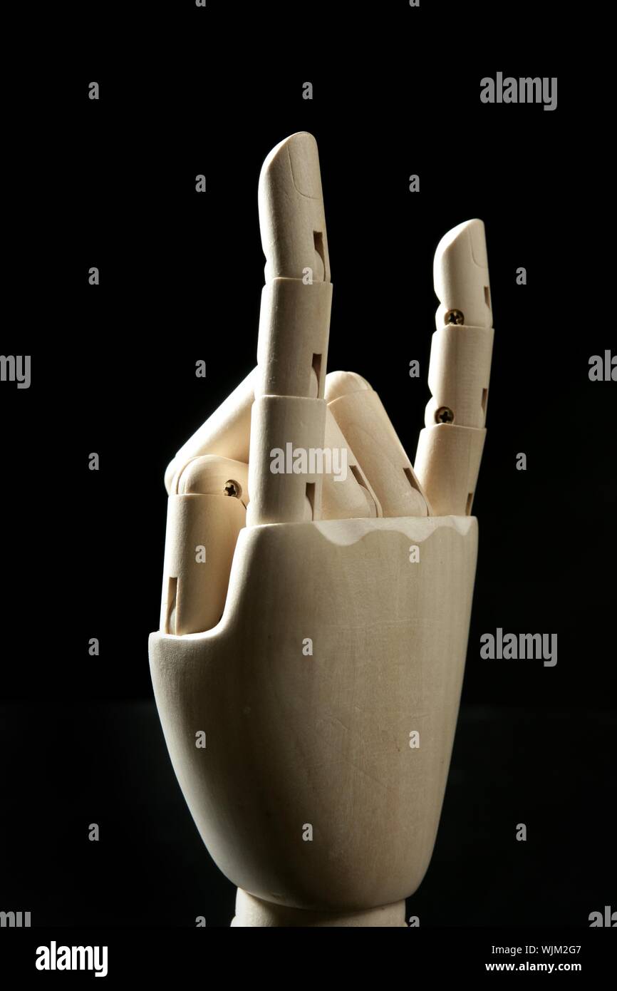 Mannequin wooden hand, horns with two fingers Stock Photo - Alamy