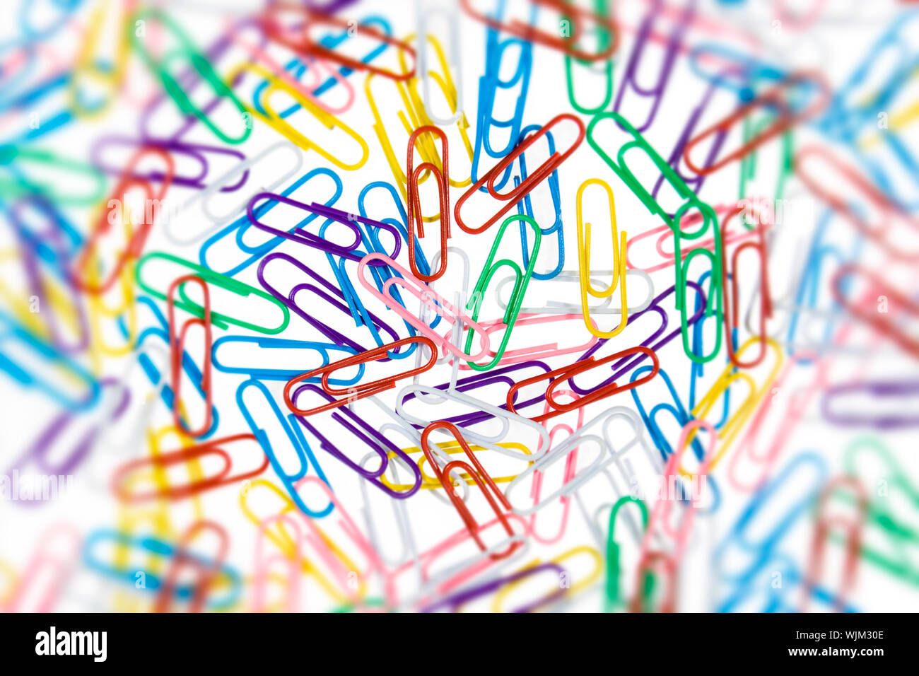 multicolored paper clips on white background Stock Photo - Alamy