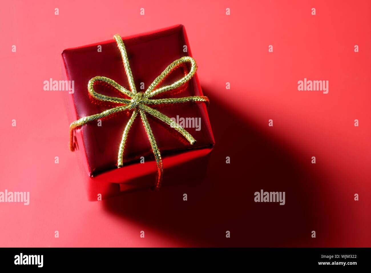 Christmas present, gift over red studio background Stock Photo - Alamy
